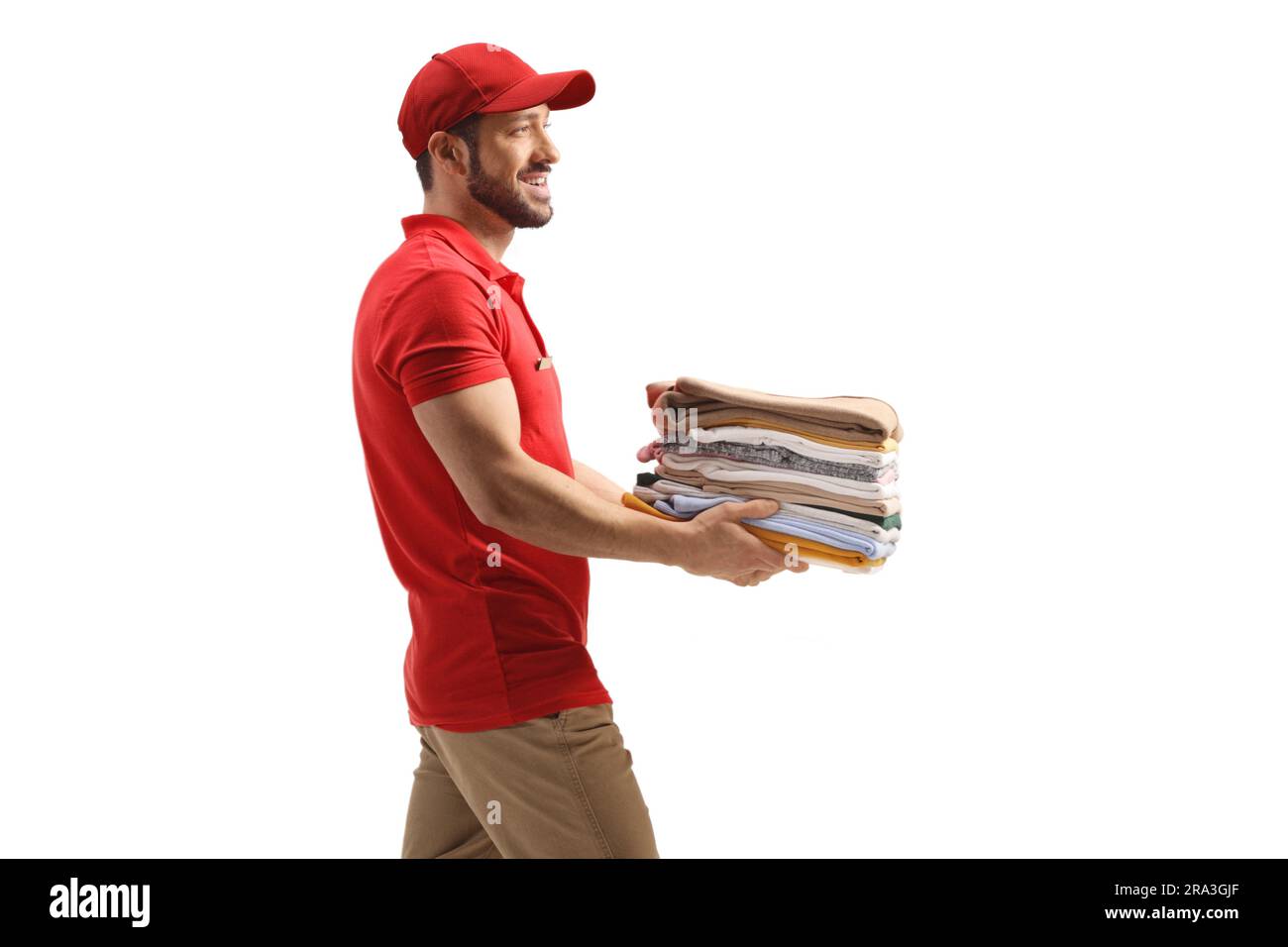 Profile shot of a delivery man carrying a pile of folded clothes and ...