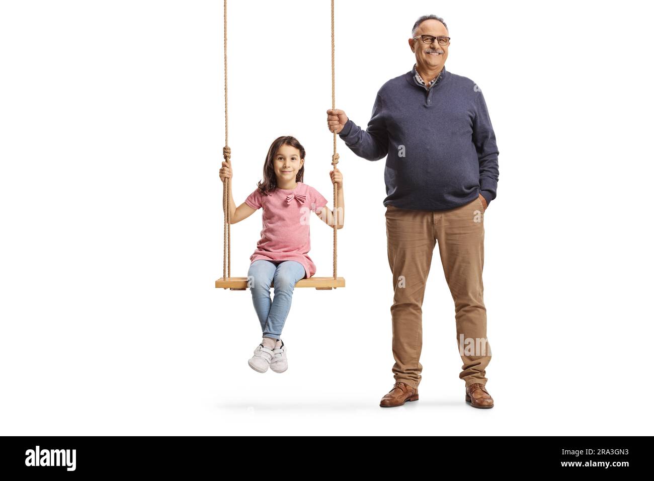 Grandfather standing next to girl on a wooden swing isolated on white ...