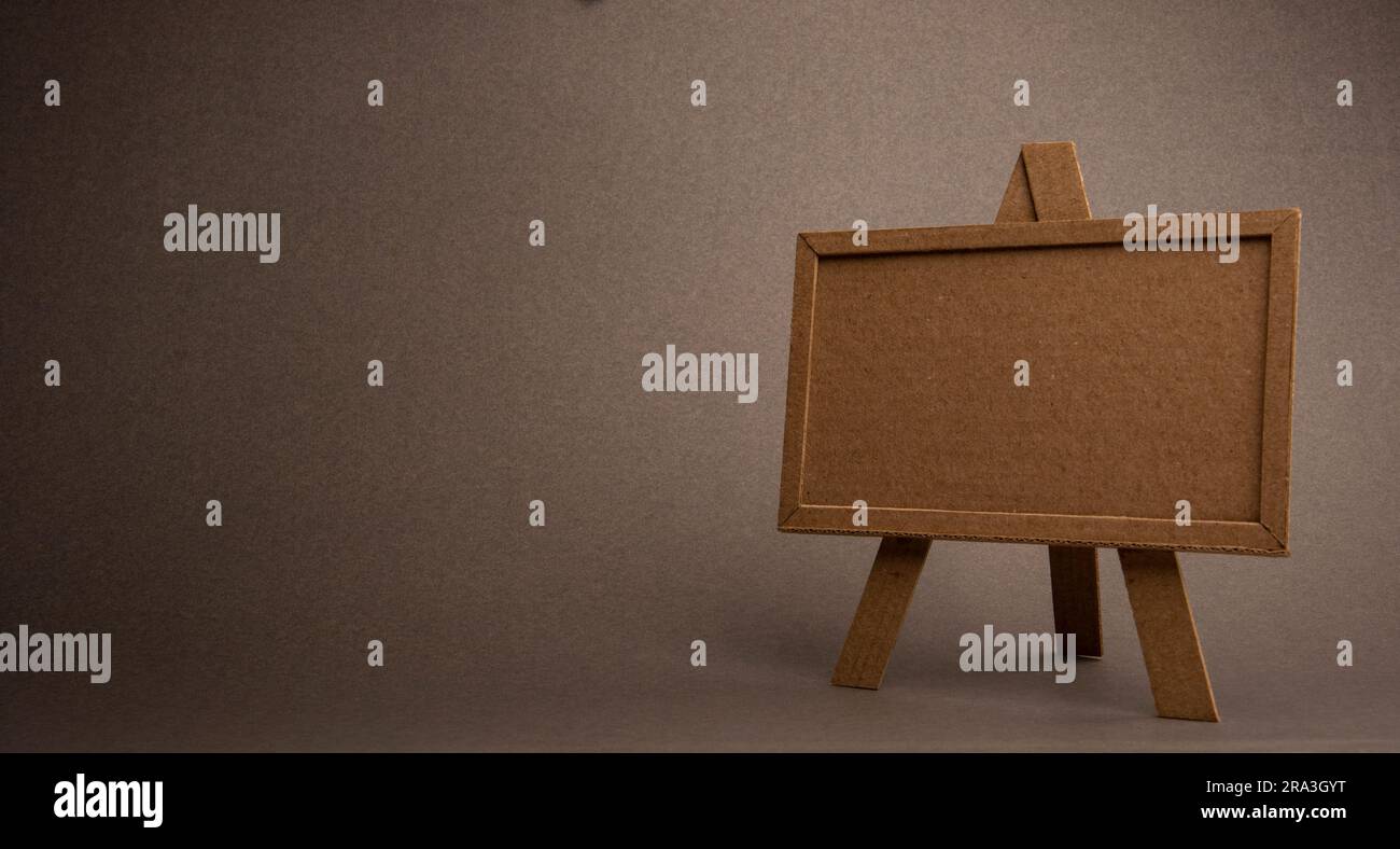 A blank brown wooden blackboard on an easel on a gray background Stock ...