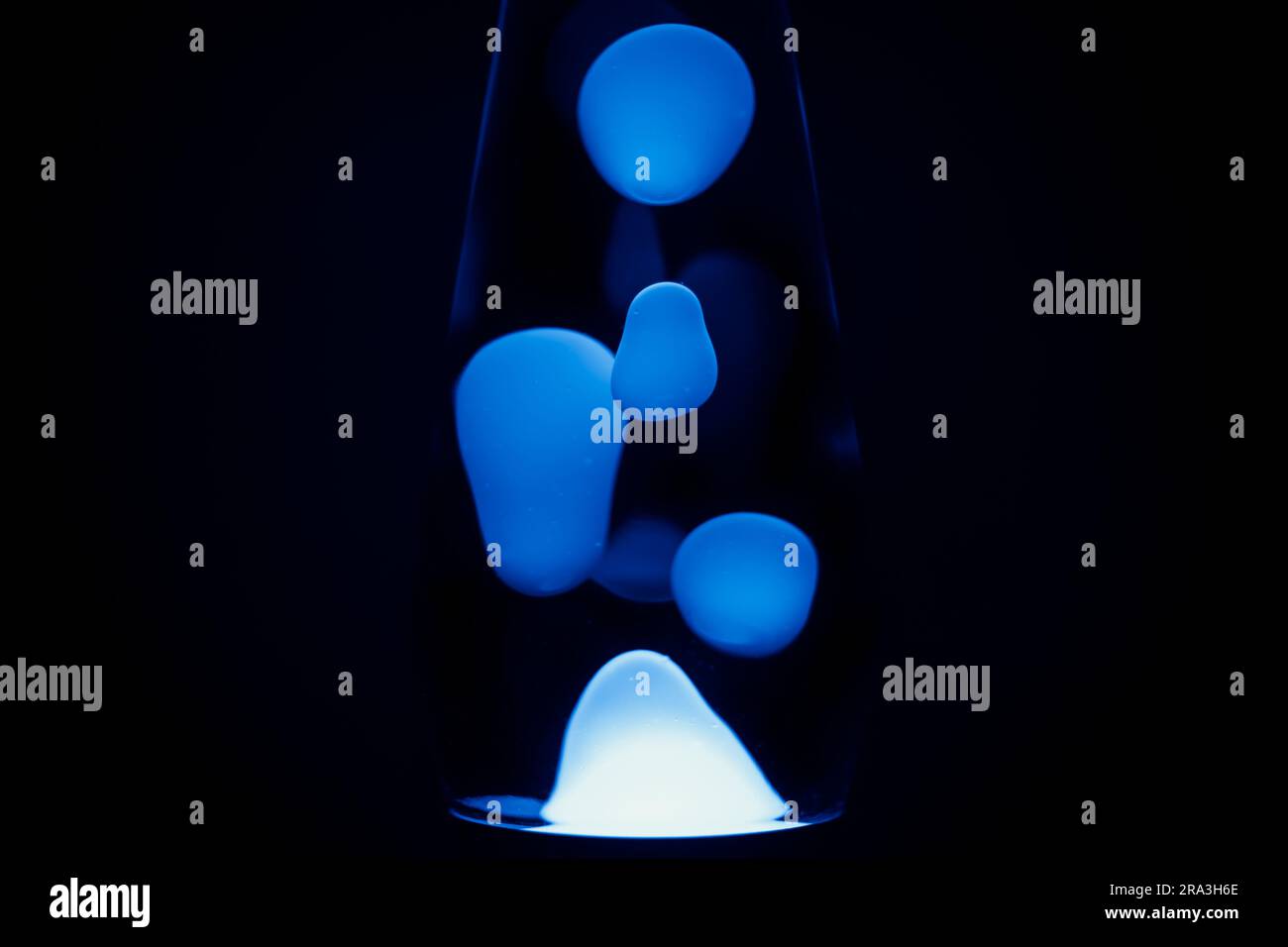 Blue lava lamp, black background, horizontal format with copy space ...