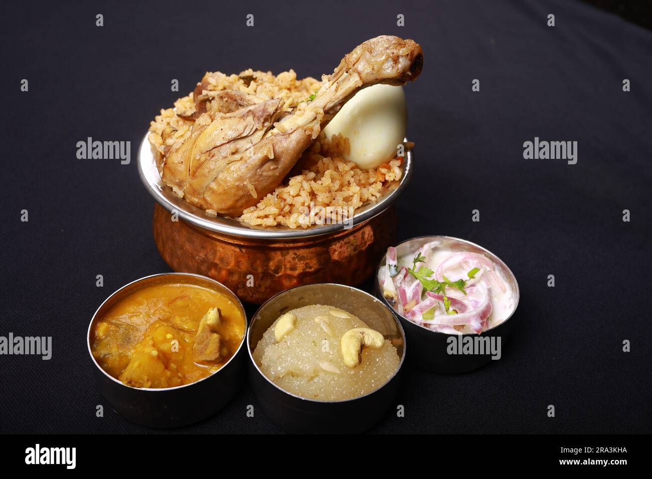 chicken biriyani with sweet and thalcha dish beautifully arranged in a ...