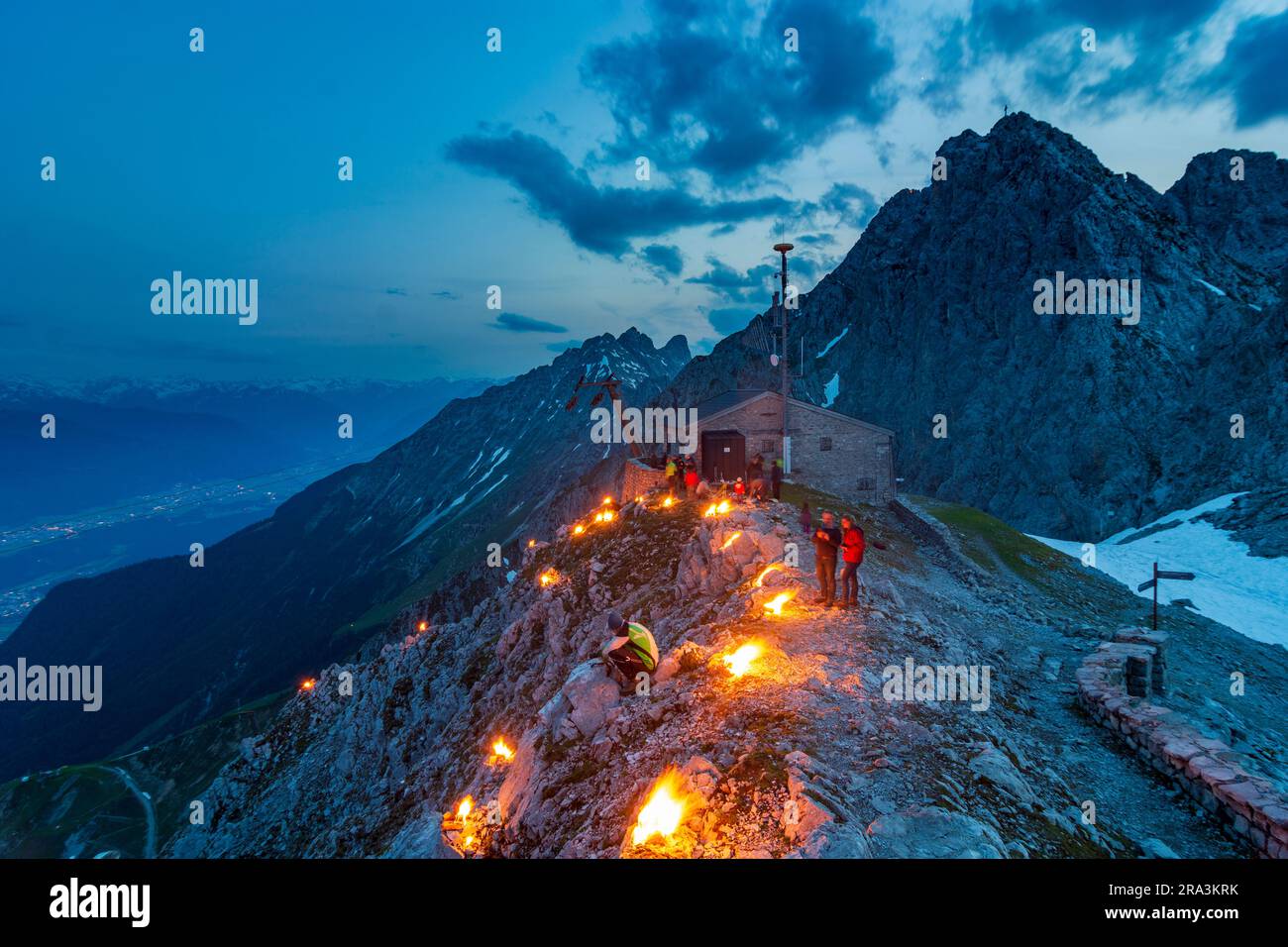 Innsbruck: solstice fire, hiker, Hafelekar, mountain range Nordkette ...