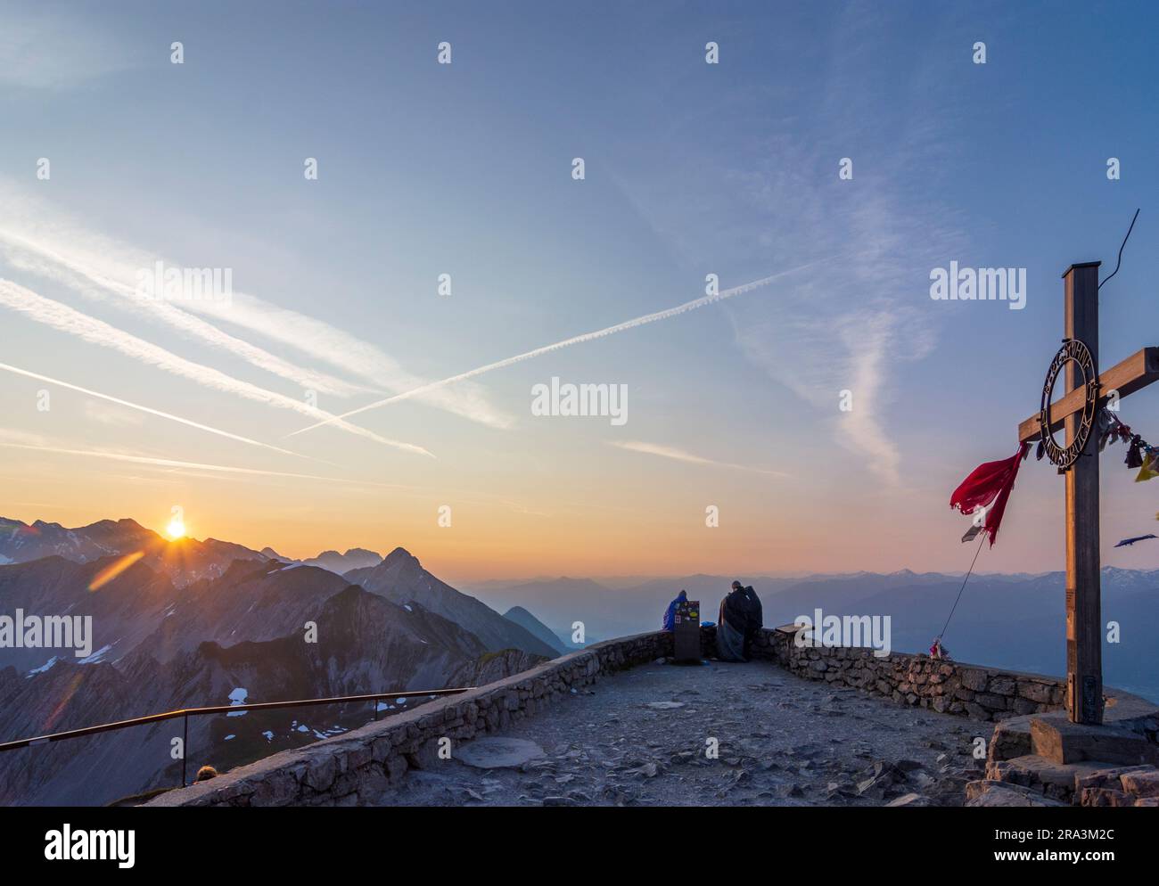 Innsbruck: sunrise on summit Hafelekarspitze, summit cross, mountain ...