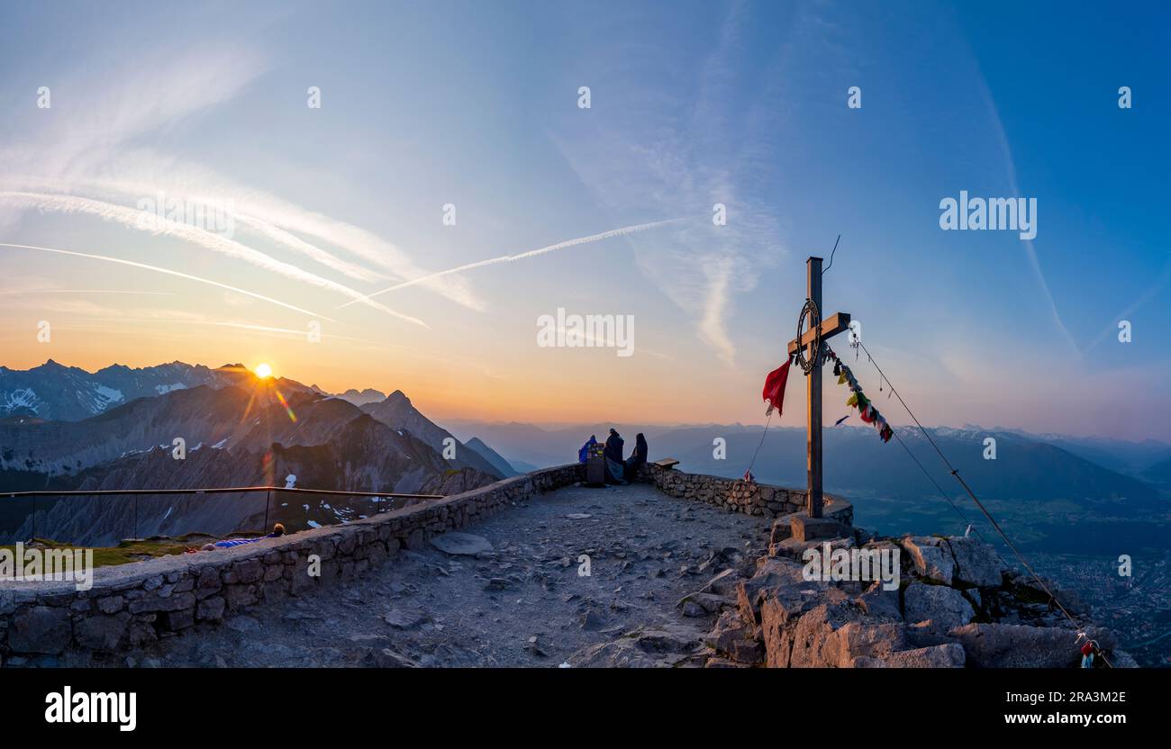 Innsbruck: sunrise on summit Hafelekarspitze, summit cross, mountain ...