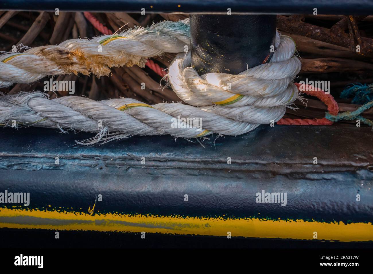 Photograph of old white rope wrapped around a steel pipe on a fishing ...