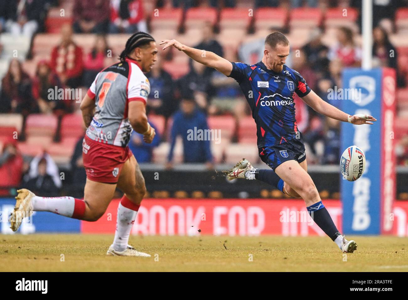 Rowan Milnes #21 of Hull KR kicks down field during the Betfred Super ...