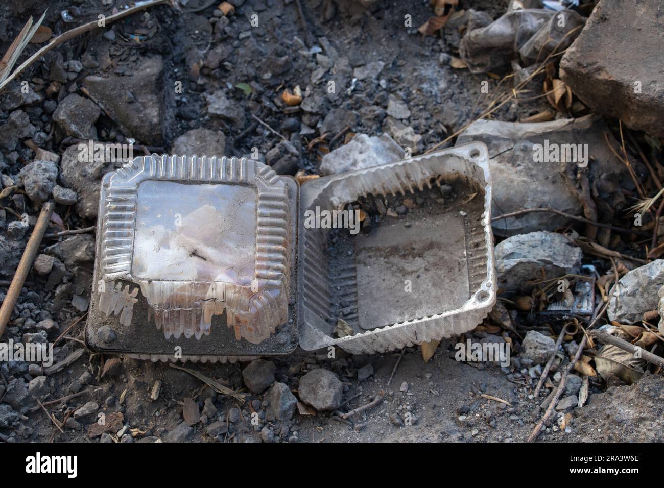 plastic packaging lies on the ground, garbage on the street ...