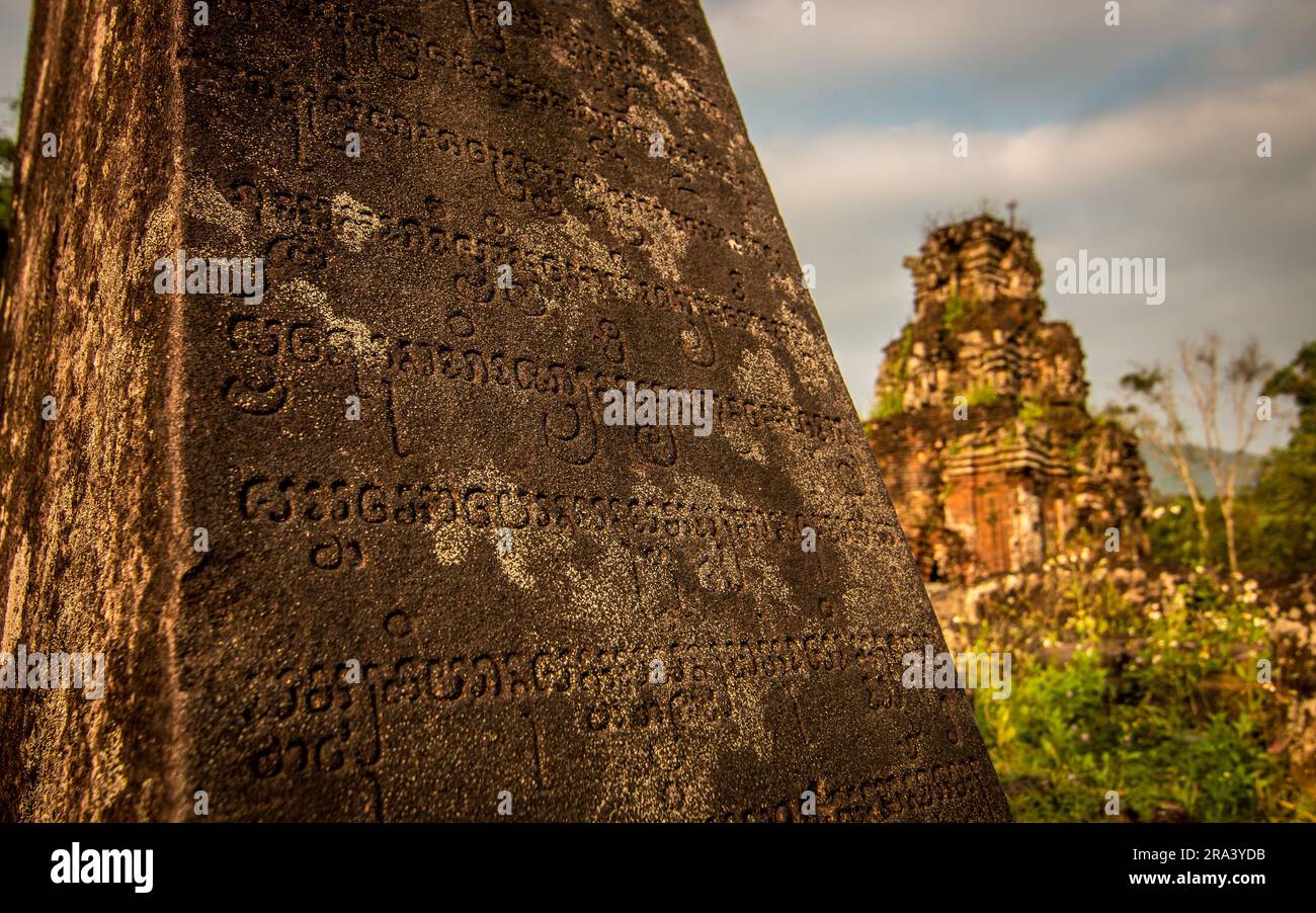 A granite gravestone in an ancient ruin setting with weathered ...