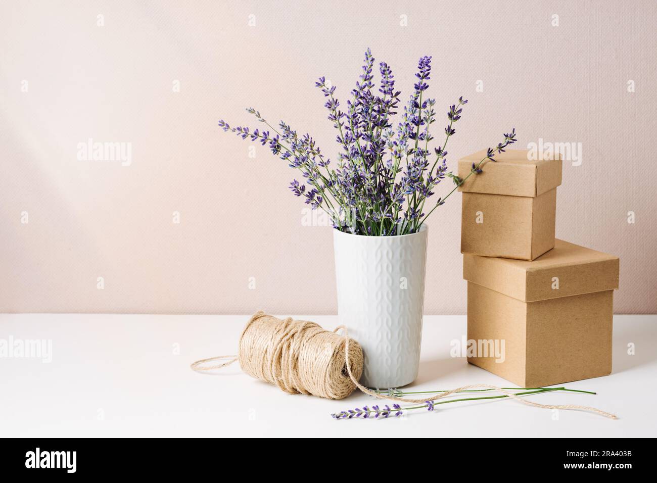 Bouquet of lavender in a vase, two small gift boxes and jute thread ...