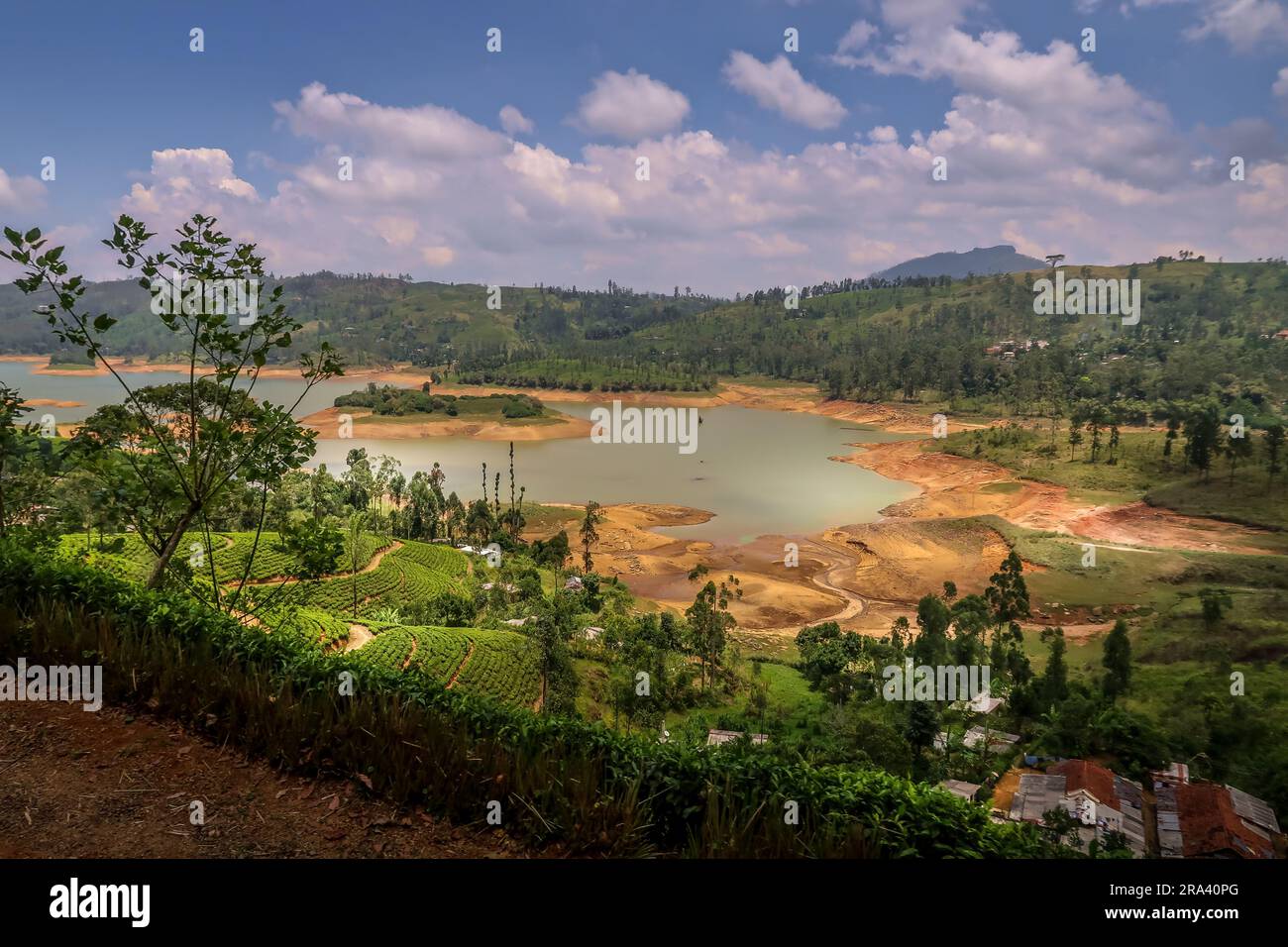 A tranquil landscape featuring a lake, winding road, and majestic hills ...