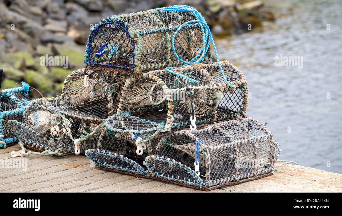 Crab traps on a harbour wall, Orkney, UK Stock Photo - Alamy