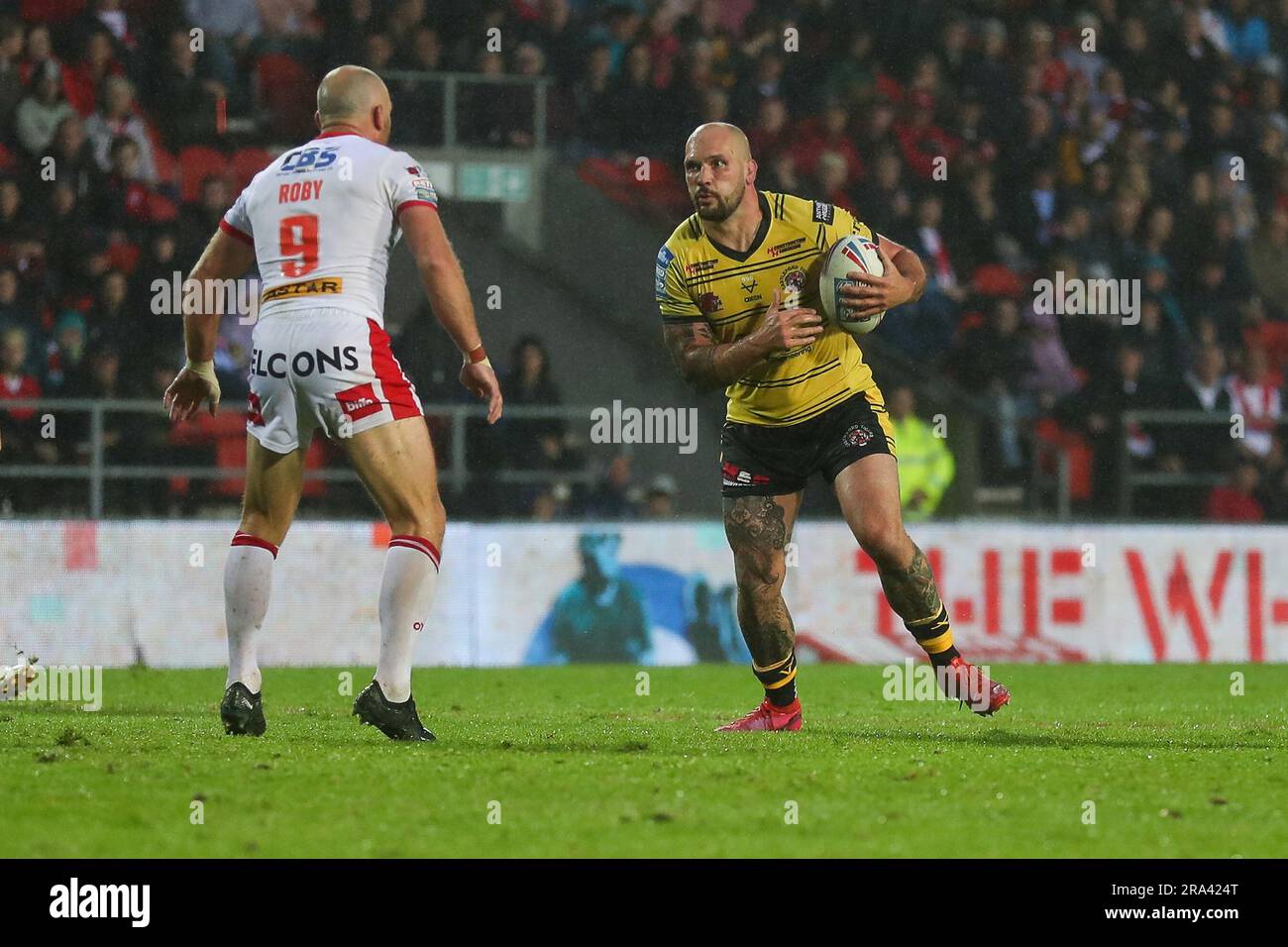 George Griffin of Castleford runs at James Roby of Saint Helens ...