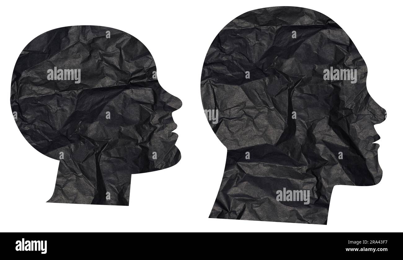 Silhouettes of heads cut out of black crumpled paper on a white ...