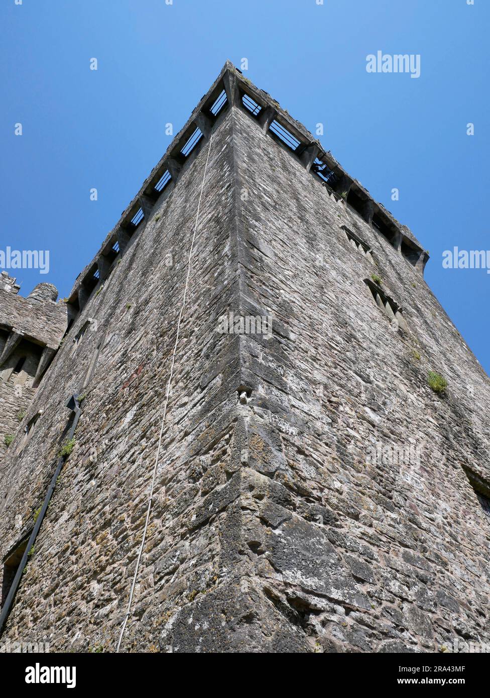 Old celtic castle tower over blue sky background, Blarney castle in ...
