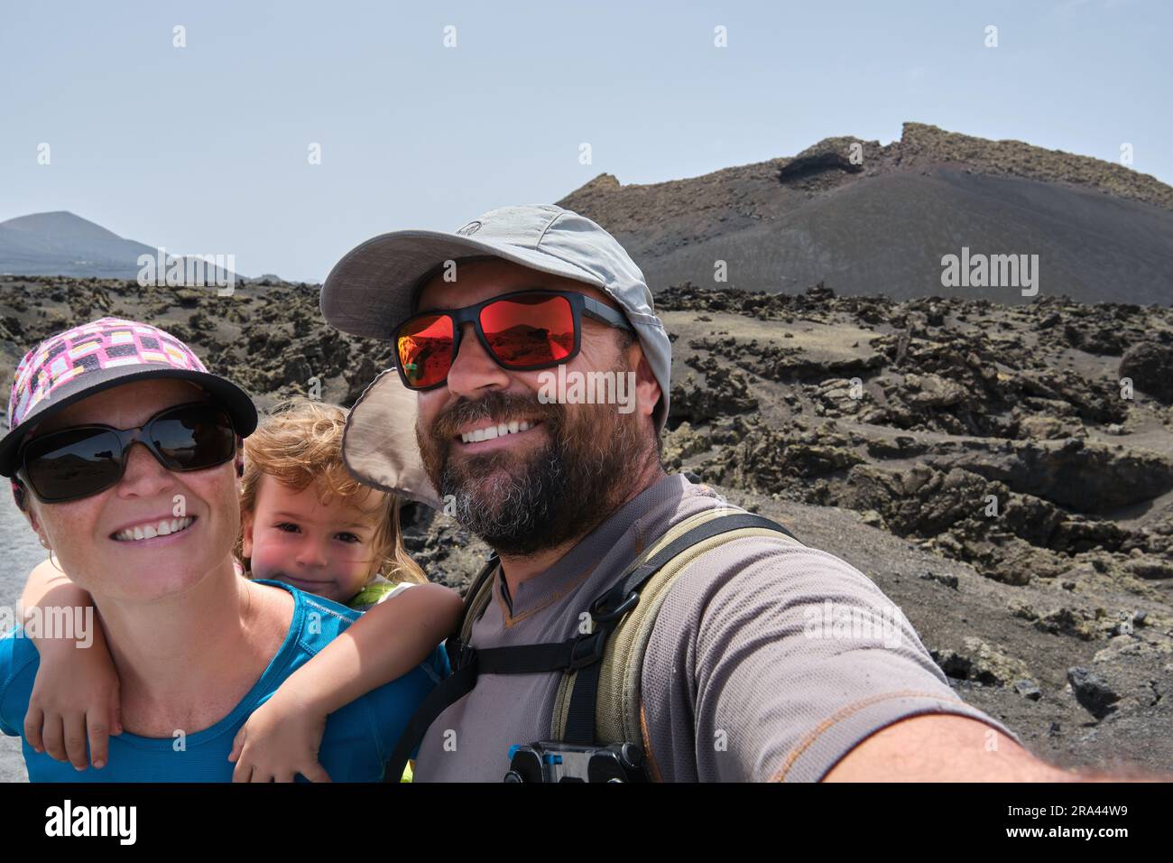 Family taking a selfie while hiking between volcanoes. El Cuervo ...
