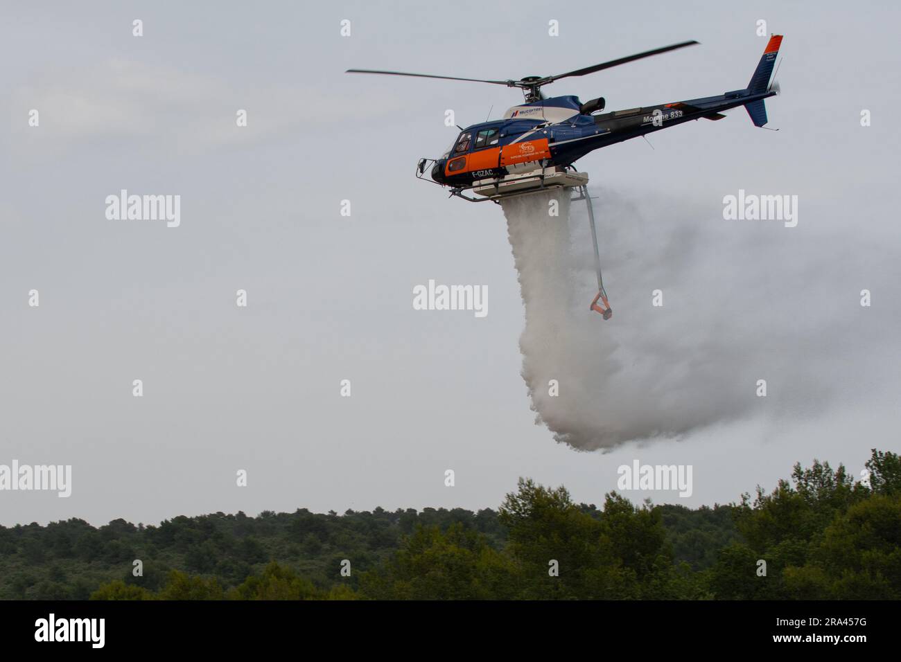 A water bomber helicopter responds to a forest fire. The Var ...