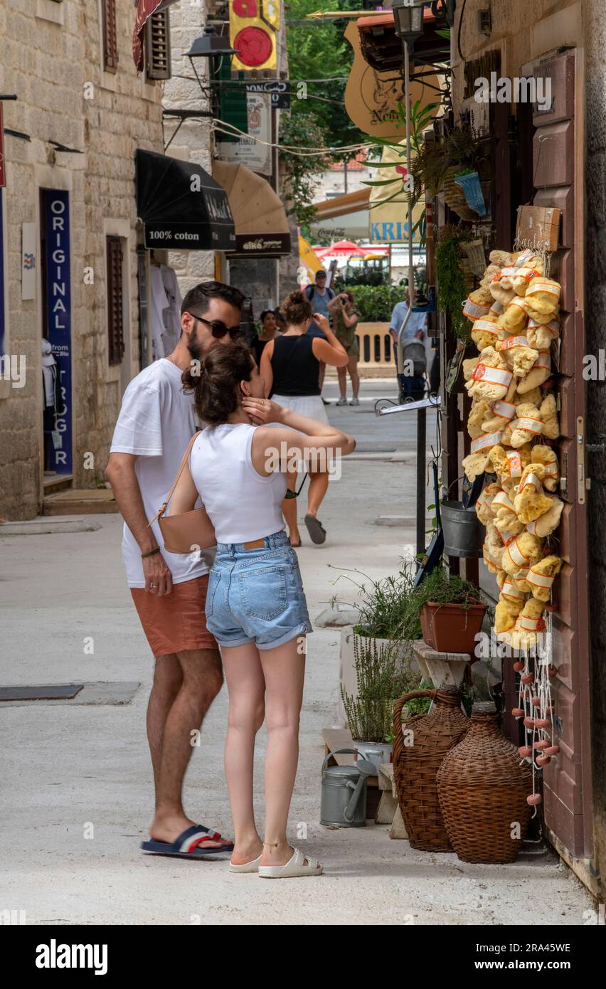 young couple on holiday in split, croatia together choosing gifts from ...