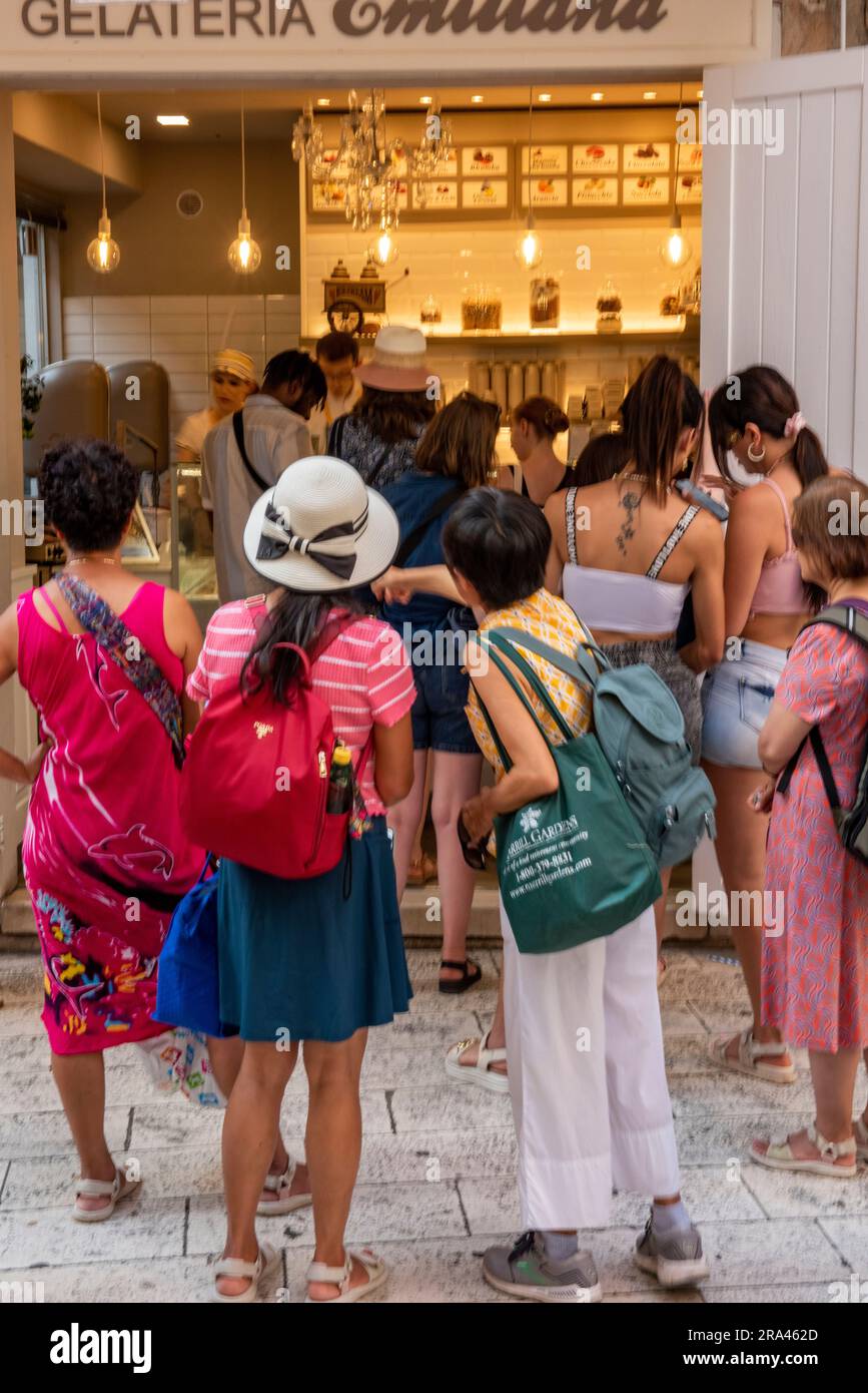 ladies in a queue at an ice cream kiosk or parlor in the old town in ...
