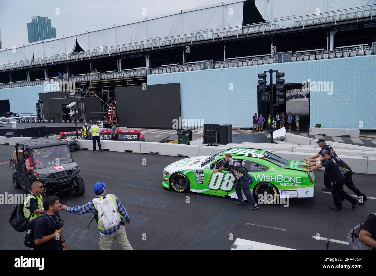 Crew members roll out the SS-Green Light Racing racing Ford, to be ...