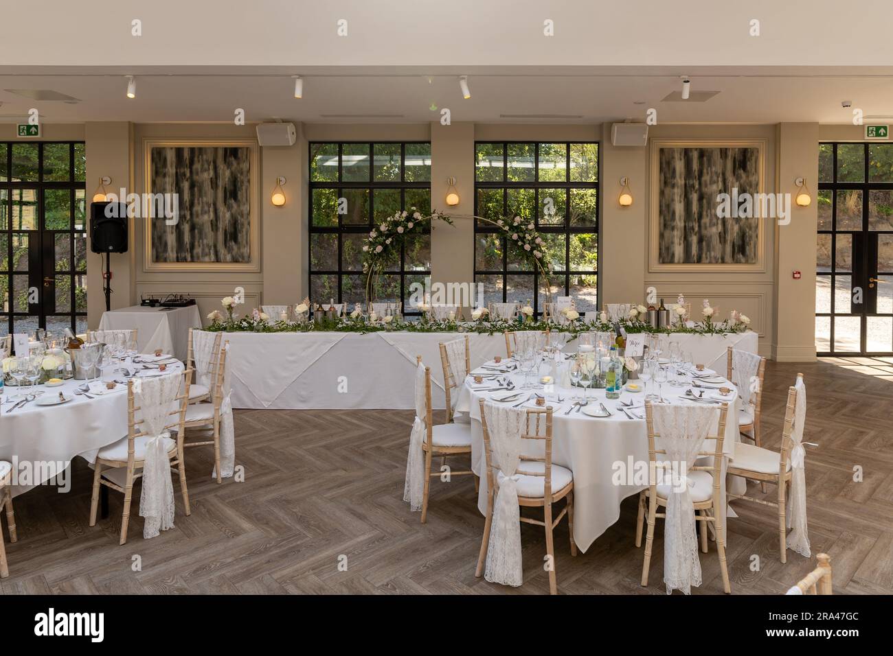 An empty wedding reception area set up with tables, ready for guests to ...