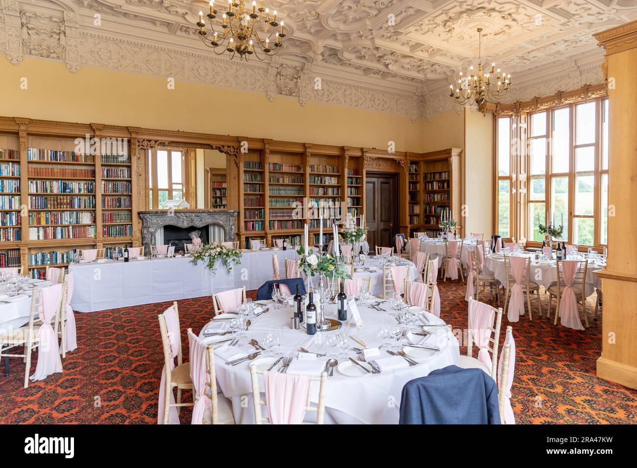 An empty wedding reception area set up with tables, ready for guests to ...
