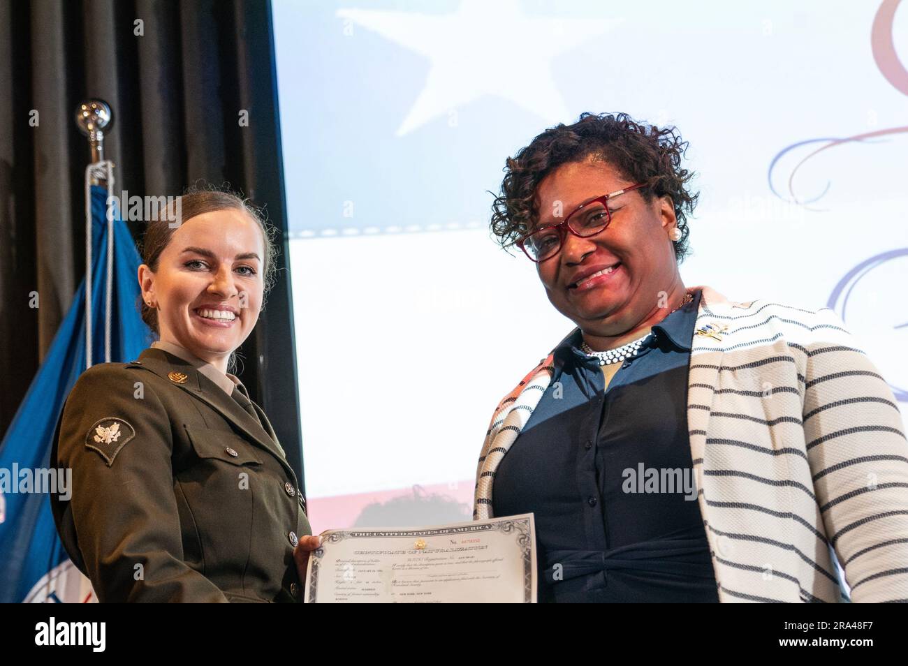 Mirjeta Tafa originally from Kosovo (L) receives certificate as ...