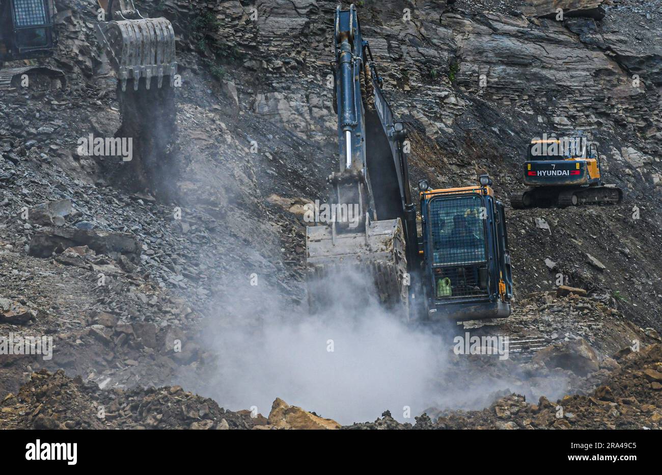 Hyundai excavators break rocks and remove debris after a landslide ...