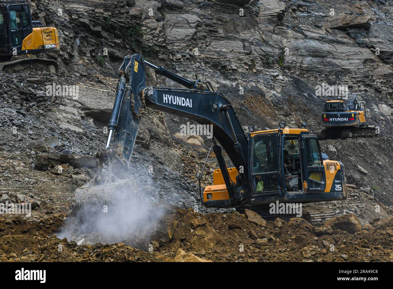 Hyundai excavators break rocks and remove debris after a landslide ...
