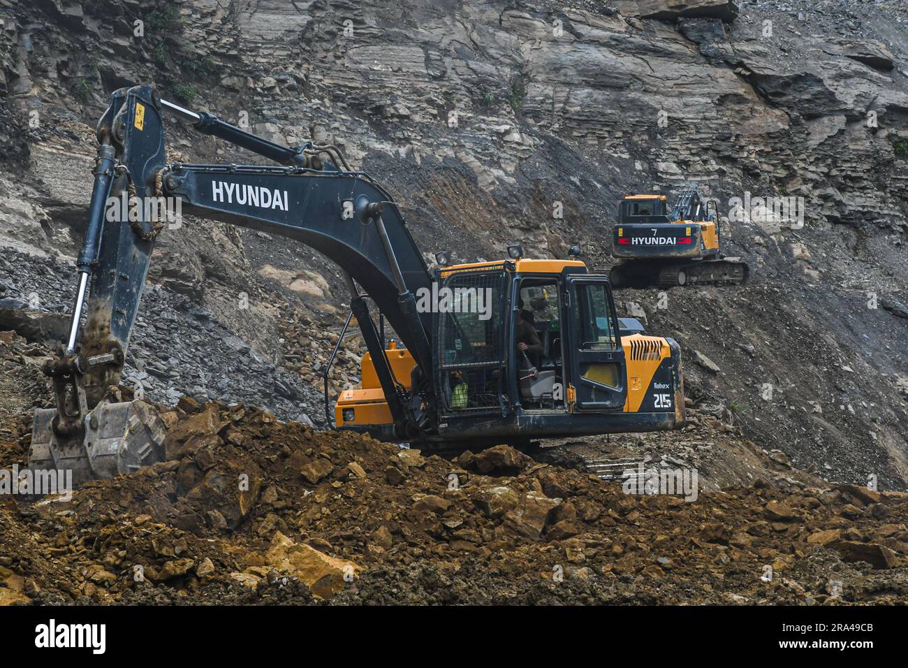 Hyundai excavators break rocks and remove debris after a landslide ...