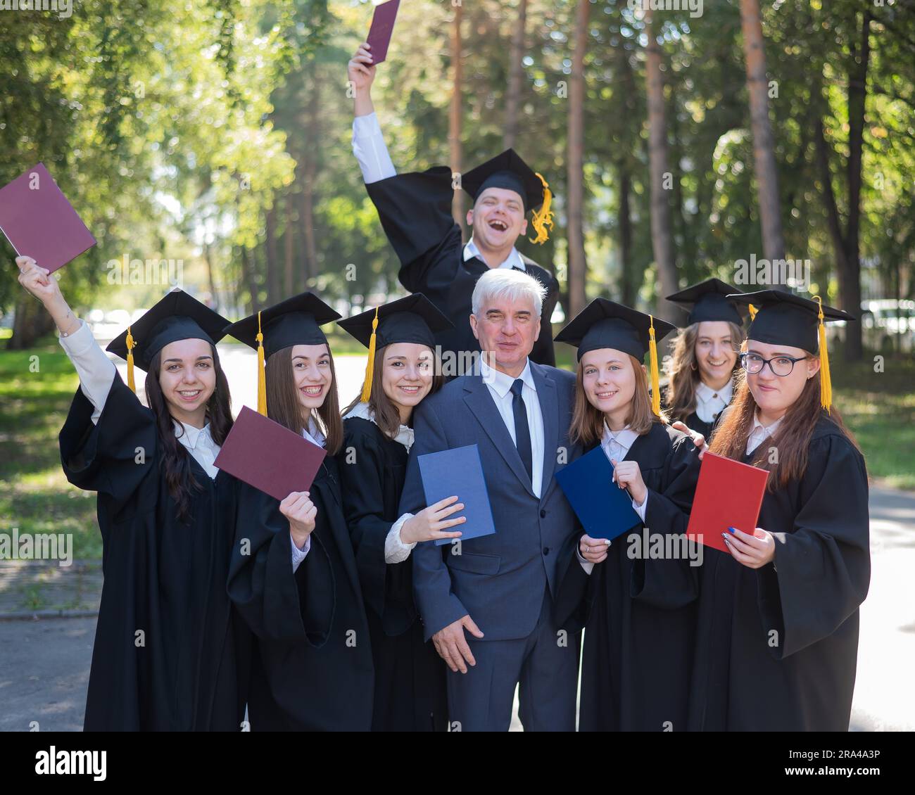University professor and seven graduates rejoice at graduation Stock ...