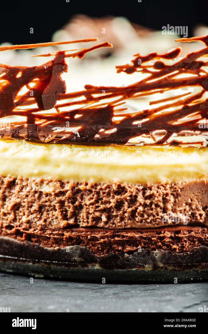 Creamy and delicate three-layered mousse cake with dark, milk, and ...