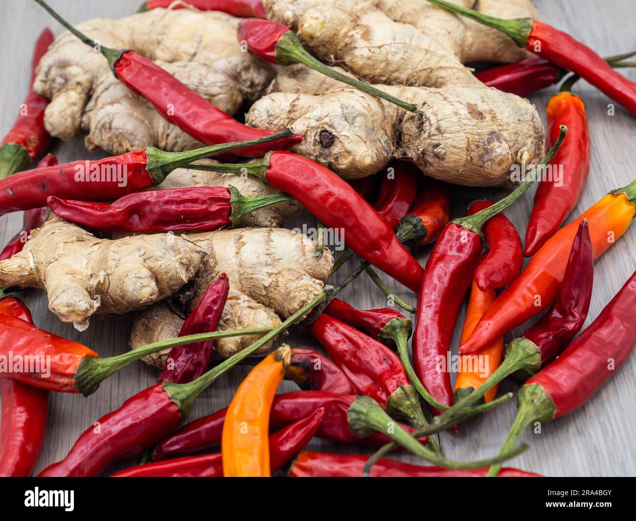 A top view of chili fruits in red and orange colors and pieces of ...