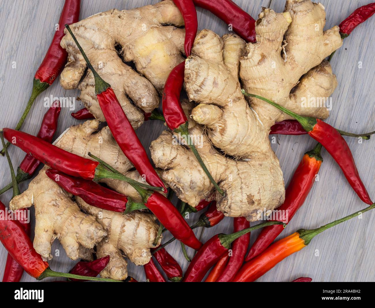 A top view of chili fruits in red and orange colors and pieces of ...