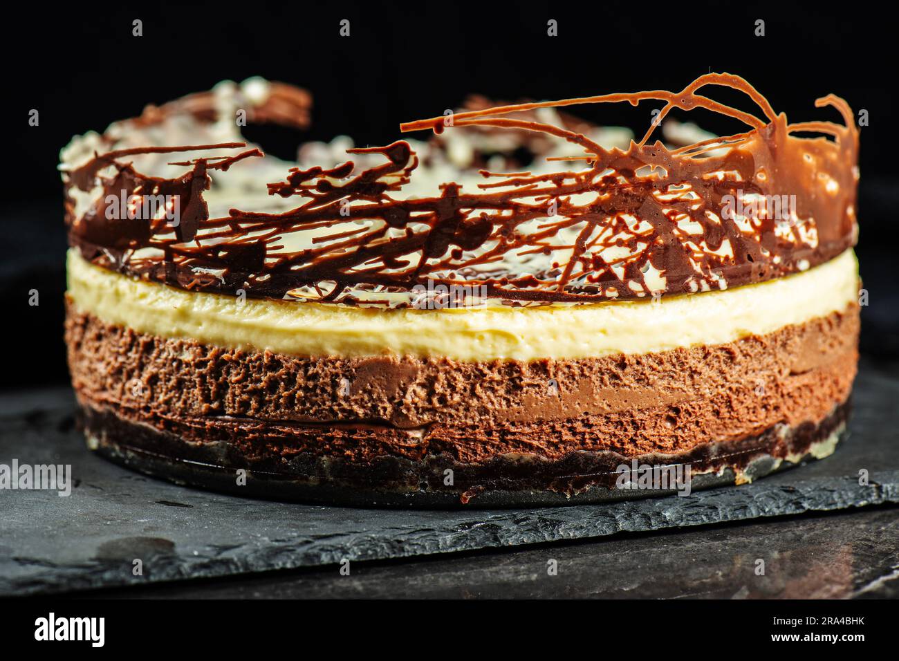 Creamy and delicate three-layered mousse cake with dark, milk, and ...