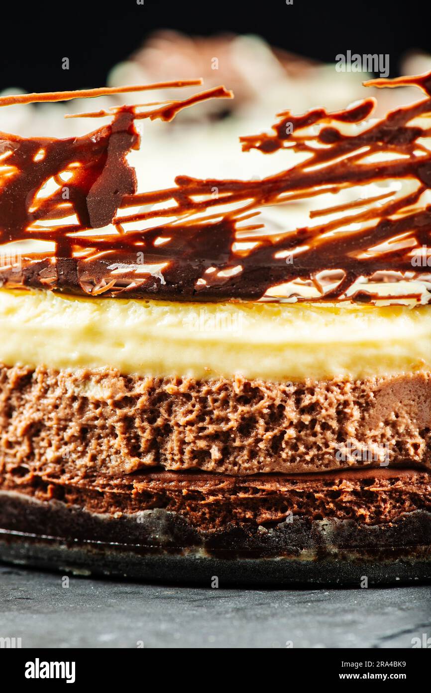 Creamy and delicate three-layered mousse cake with dark, milk, and ...