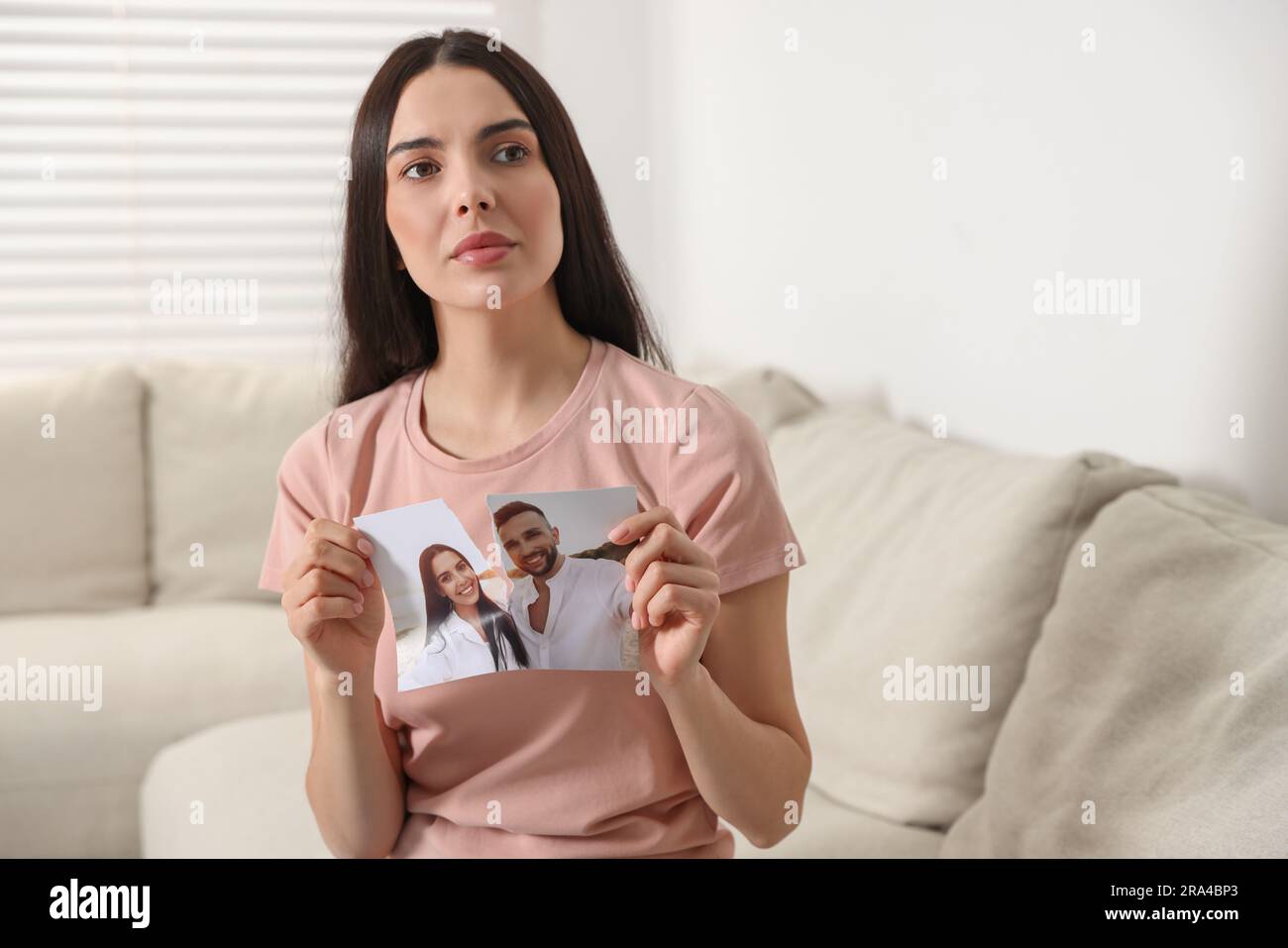 Woman ripping photo at home. Divorce concept Stock Photo - Alamy