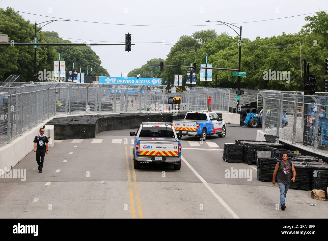 Protective fencing and a wall of tires are being set up along a portion ...