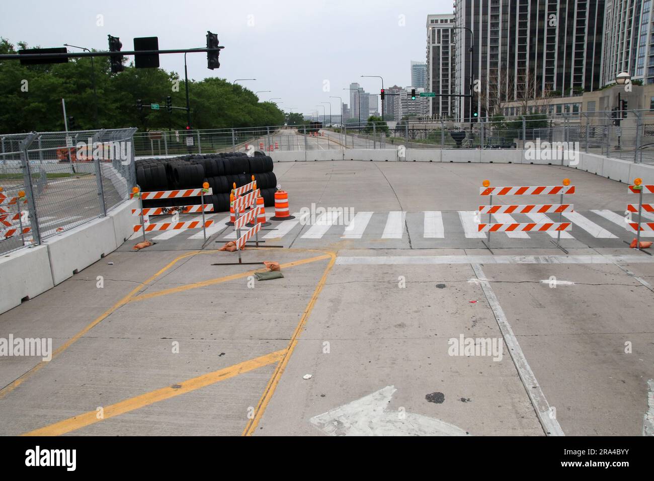 Protective fencing and a wall of tires are being set up along a portion ...