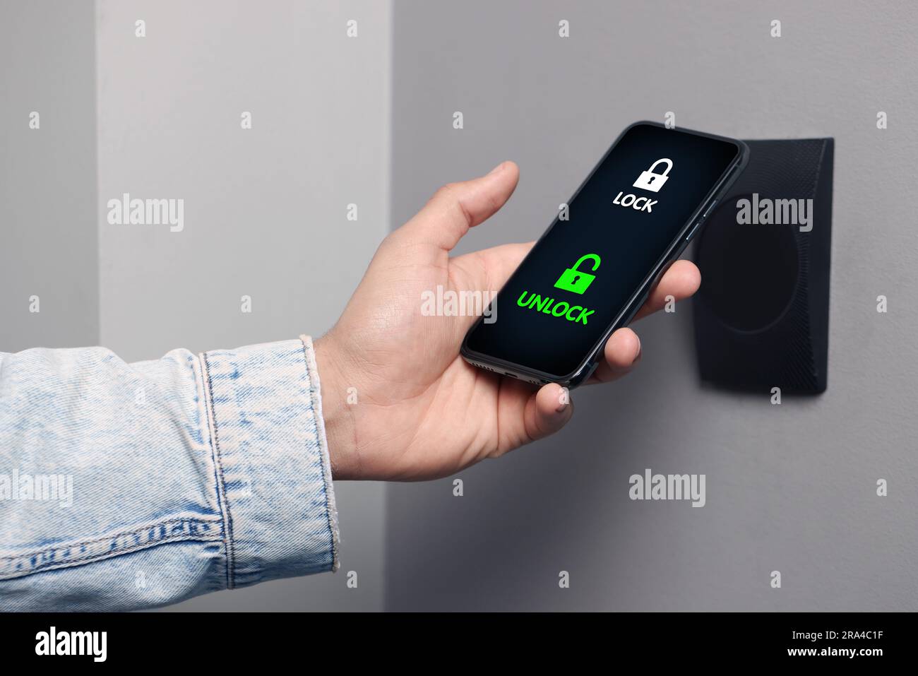 Man unlocking door using mobile phone, closeup. Illustration of closed ...