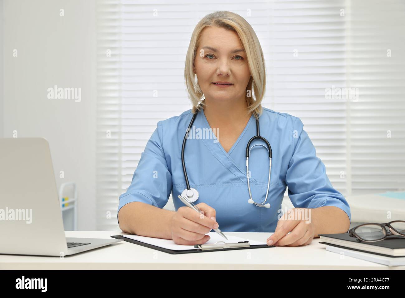 Physician writing information cure in hi-res stock photography and ...
