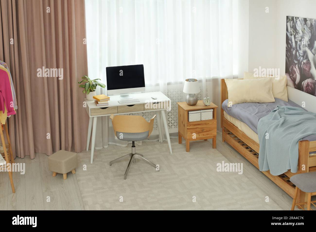 Stylish teenager's room interior with computer and comfortable bed ...