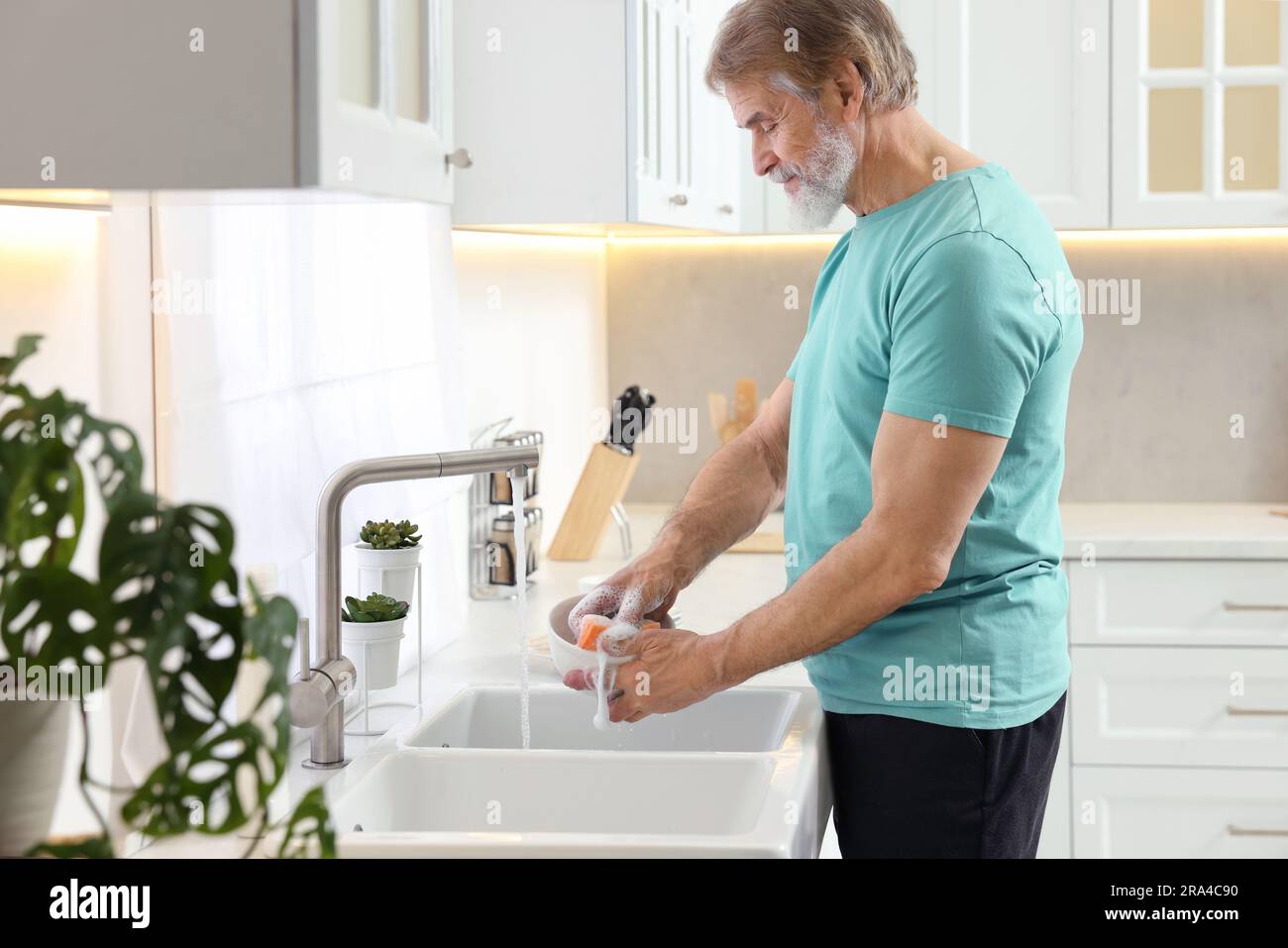 Senior man pouring kitchen hi-res stock photography and images - Alamy