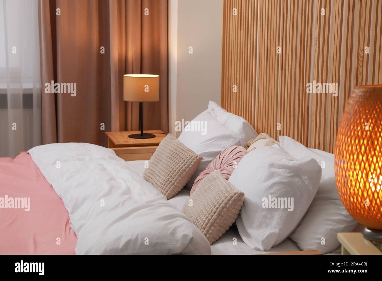 Comfortable bed with cushions in bedroom. Interior design Stock Photo - Alamy