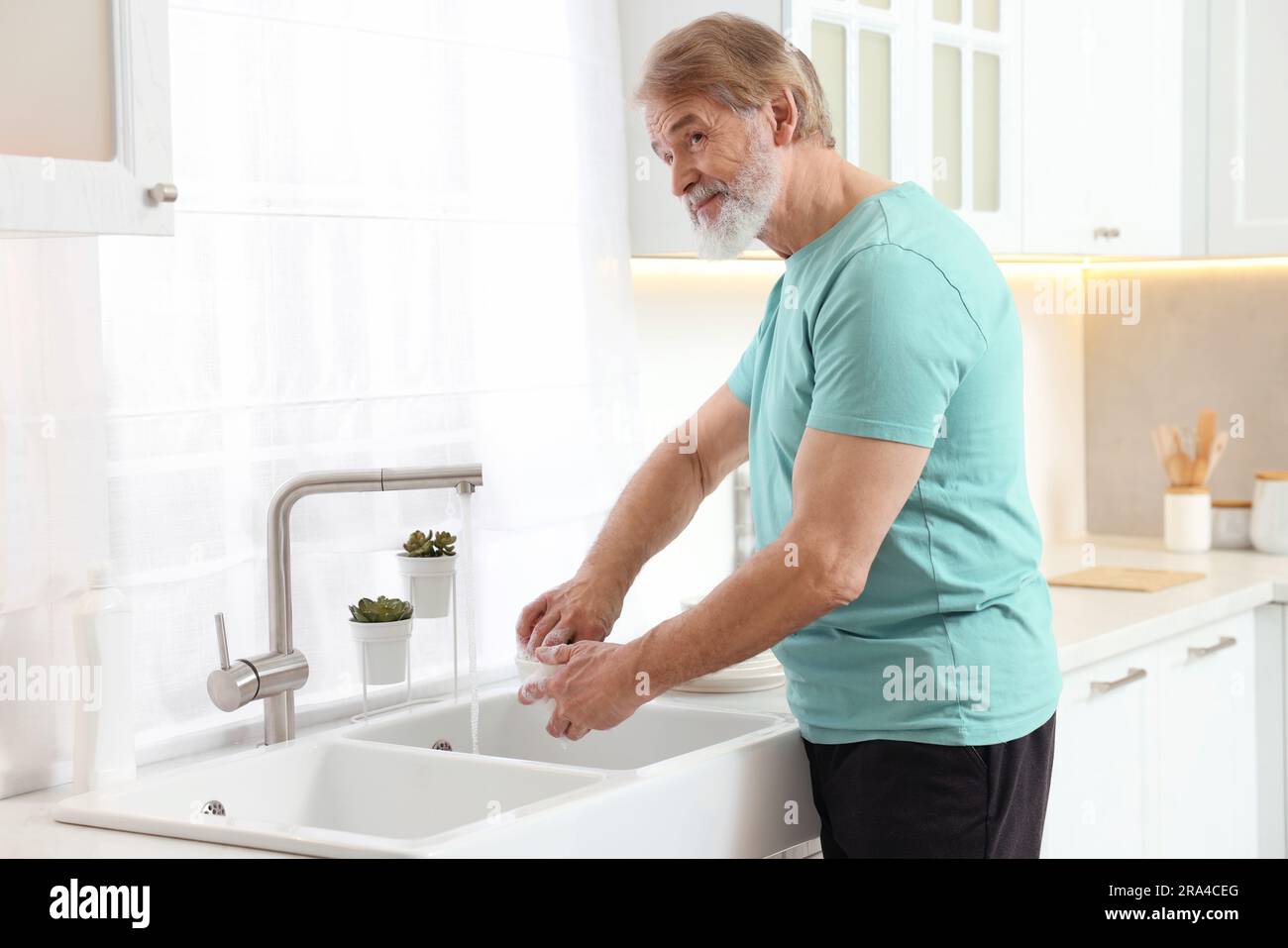 Senior man pouring kitchen hi-res stock photography and images - Alamy