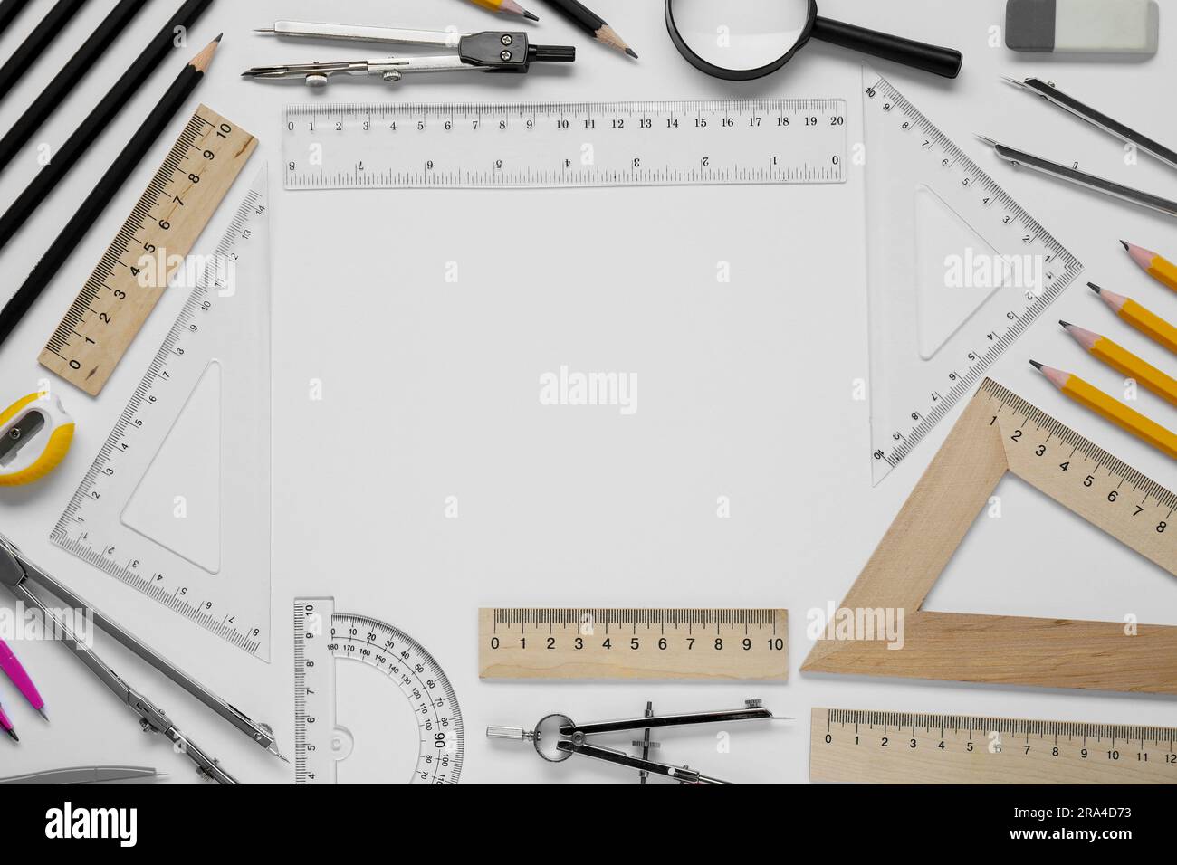 Flat lay composition with different rulers and compass on white ...