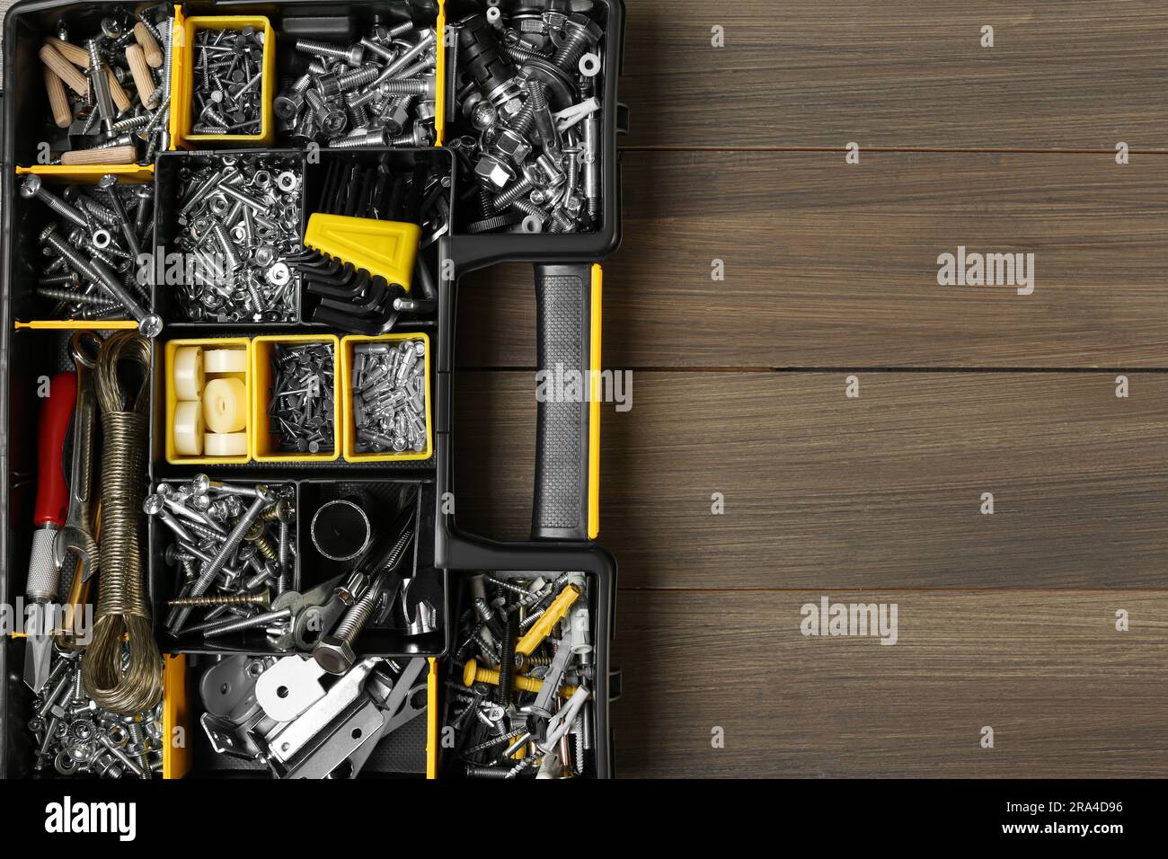 Box with different furniture fittings and tools on wooden table, top ...