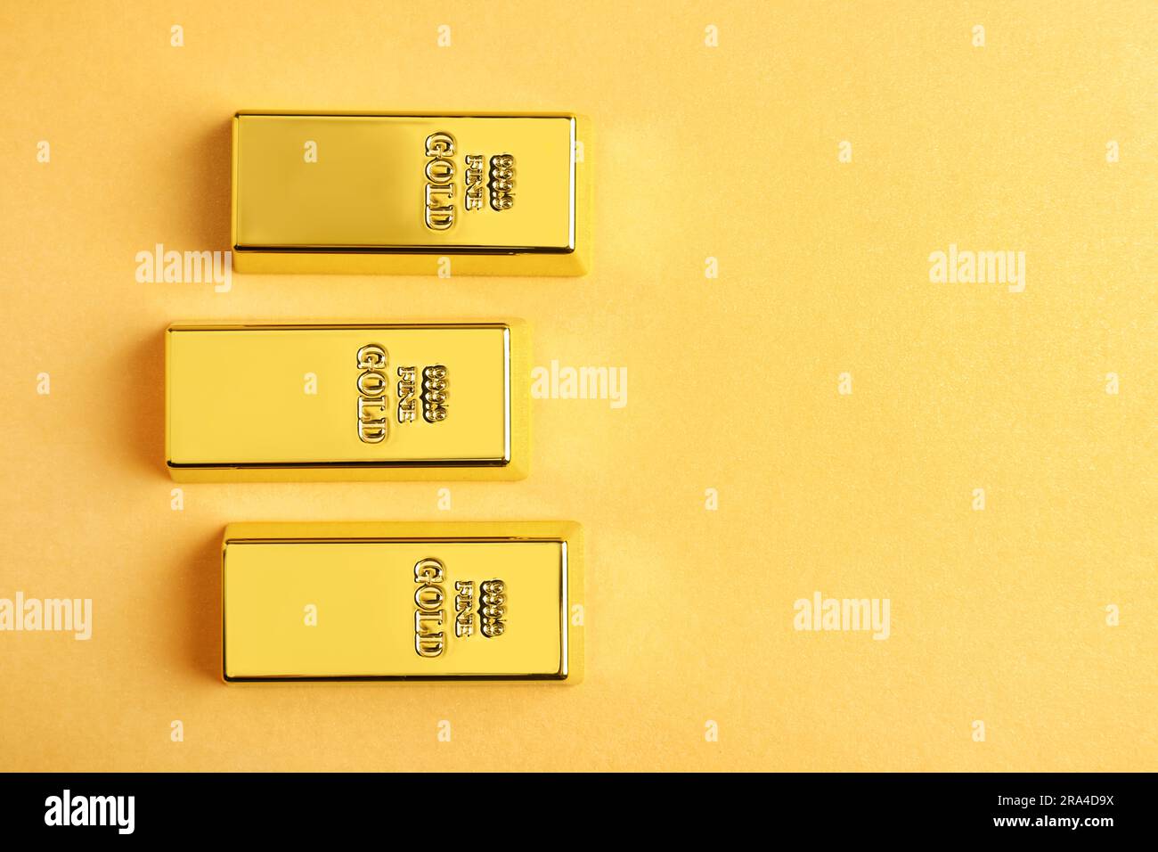 Shiny gold bars on pale orange background, flat lay. Space for text Stock Photo - Alamy