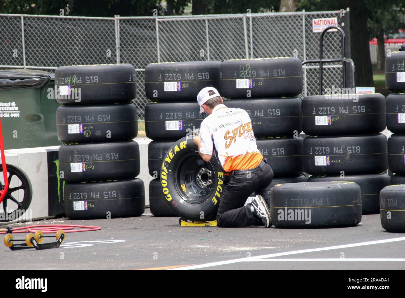 Pit crew workers move tires to prepare them for the the inaugural ...