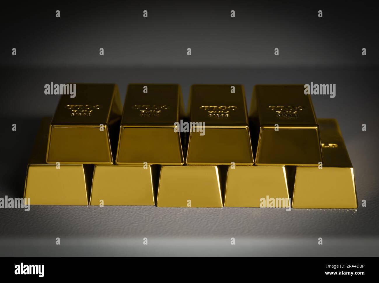 Many gold bars on light grey textured table Stock Photo - Alamy