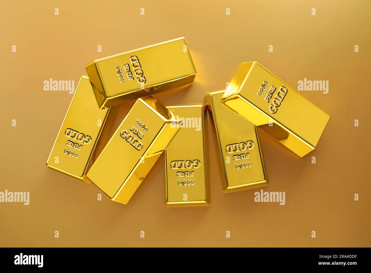 Shiny gold bars on color background, flat lay Stock Photo - Alamy